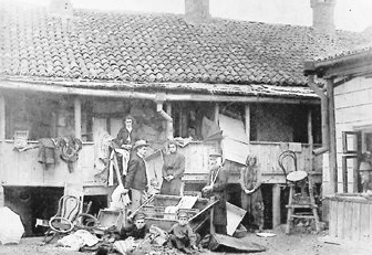 Victims of the Pogrom Outside their Ruined Home